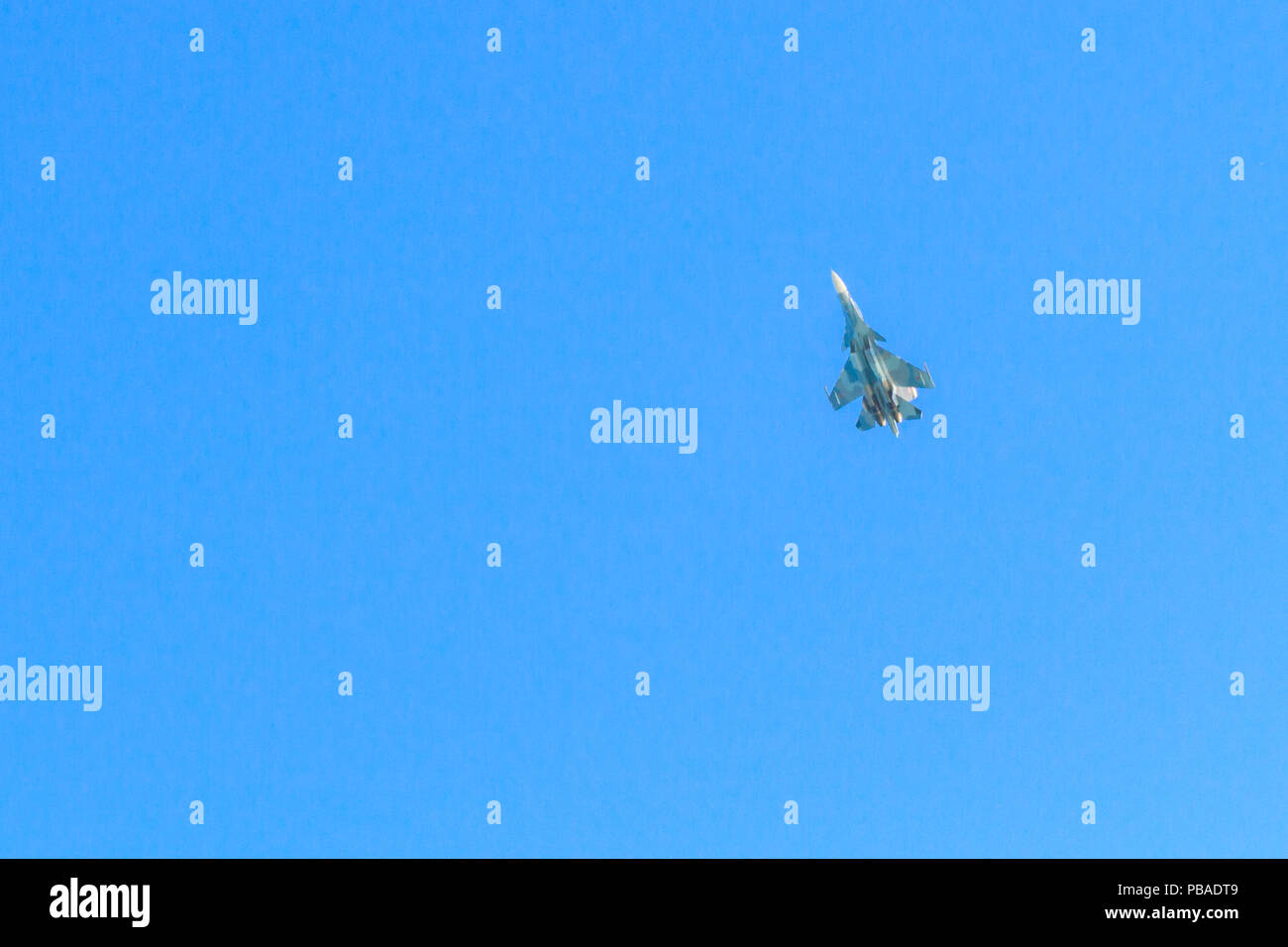 Military fighter jet far in blue sky Stock Photo - Alamy