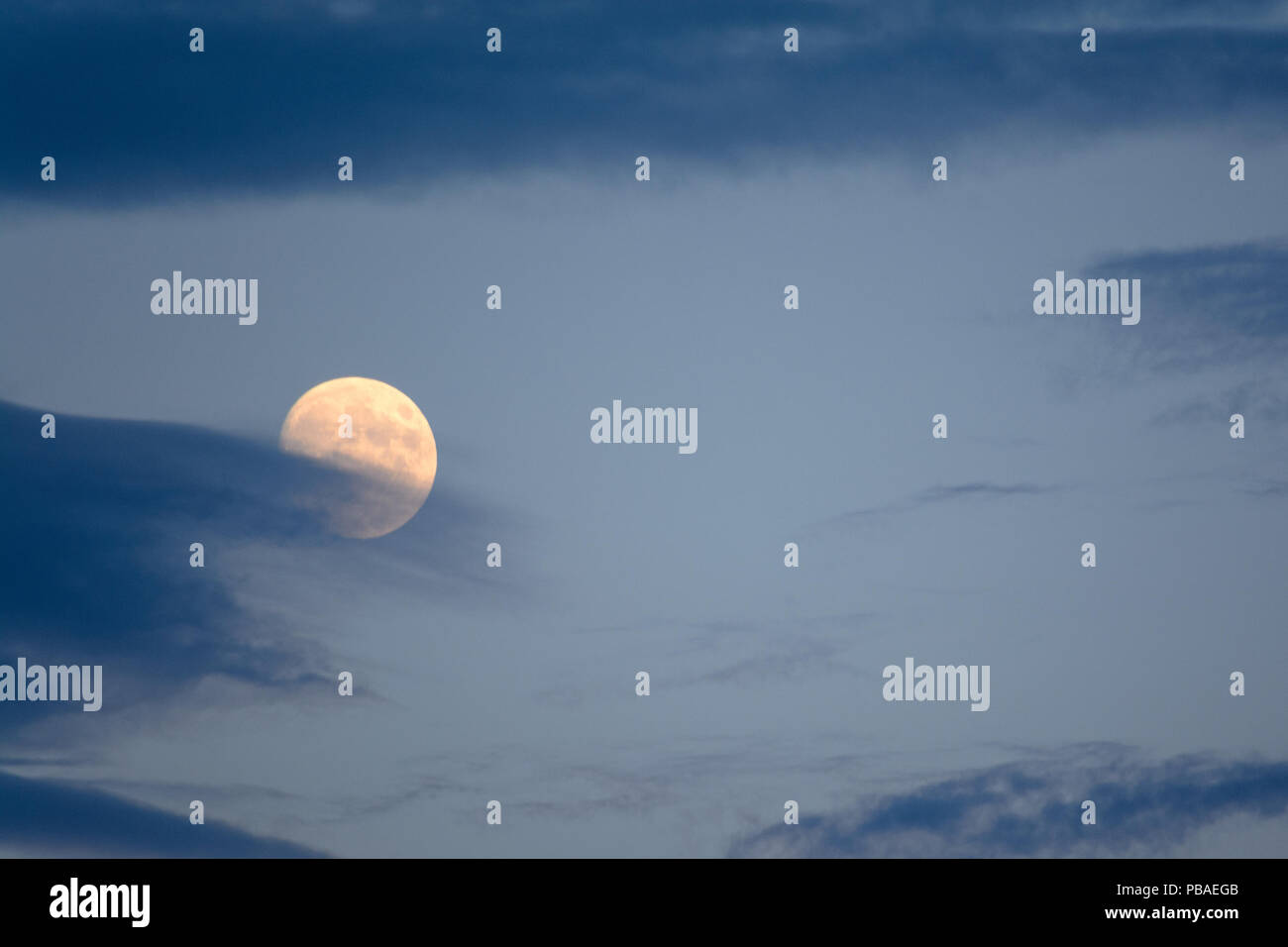 Full moon and clouds at sunset Stock Photo - Alamy