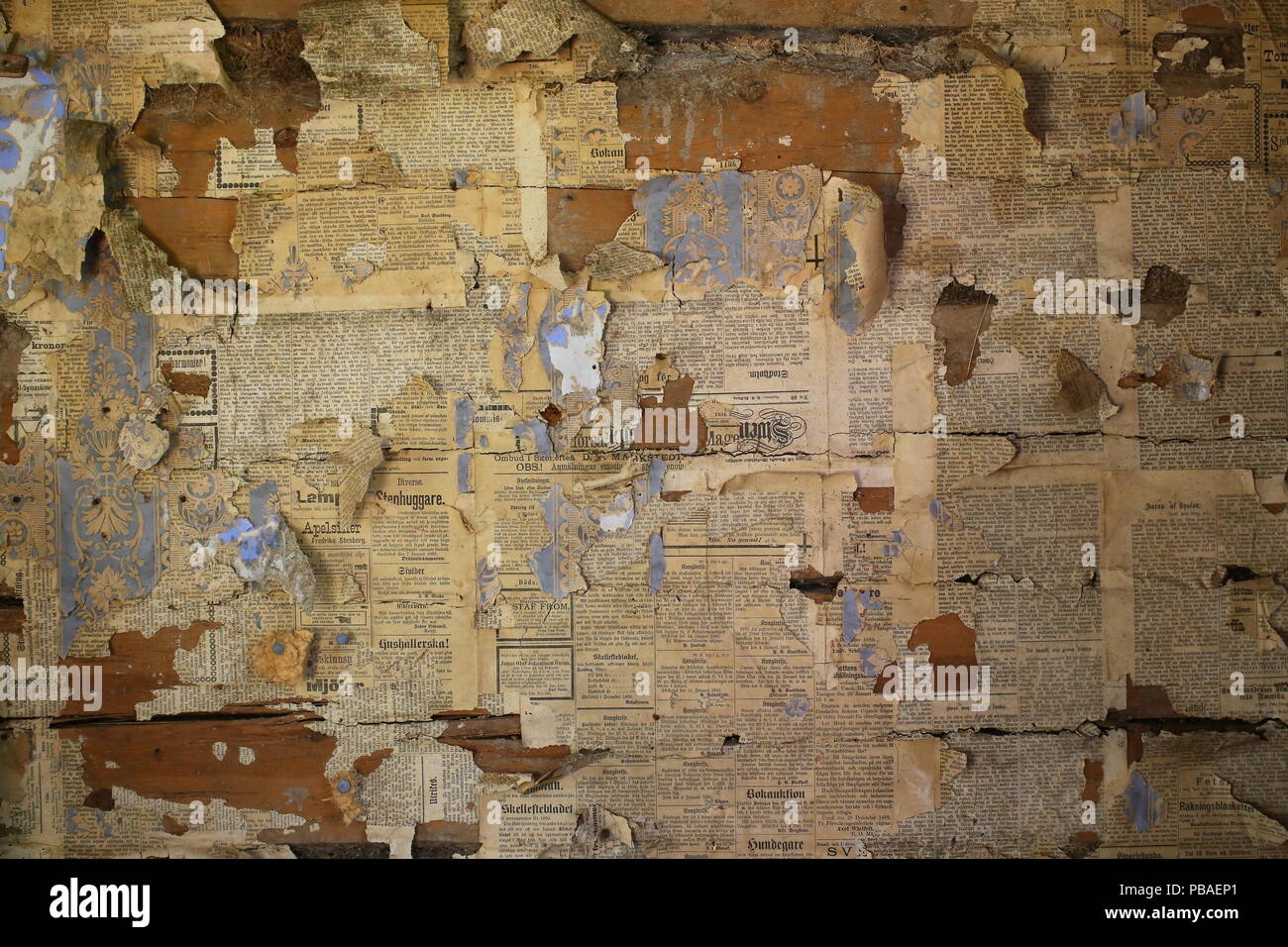 Old wooden wall decorated with Swedish newspaper fragments from 1890 ...