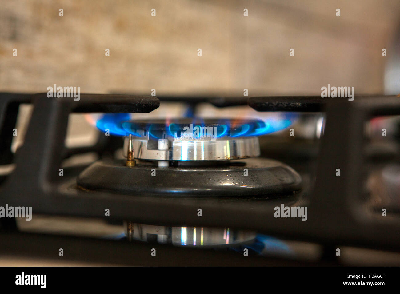 Burning blue gas on the dark stove. Burner gas stove, concept of energy ...