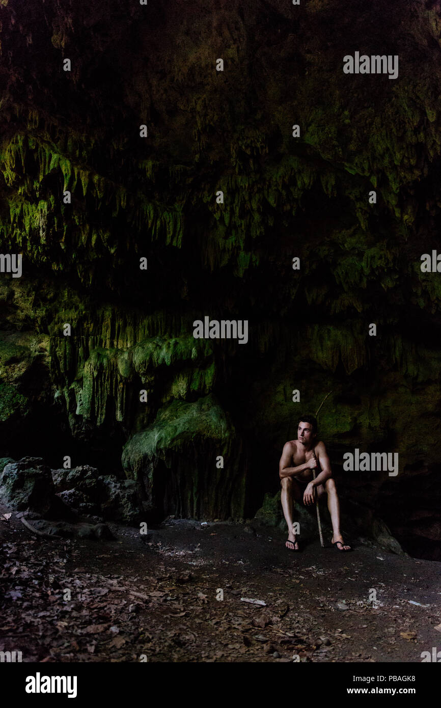 Man exploring natural cave systems in Fiji Stock Photo - Alamy