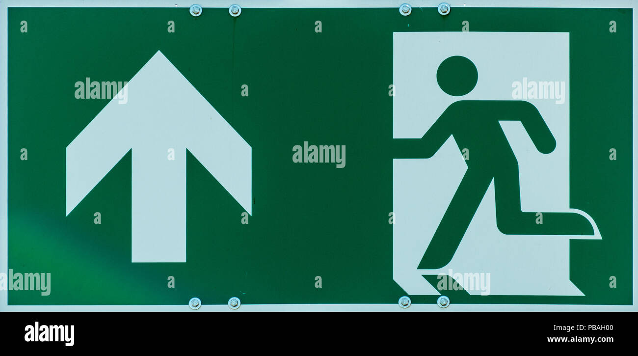 Sign with the pictogram of a walking person and an arrow in white on a ...