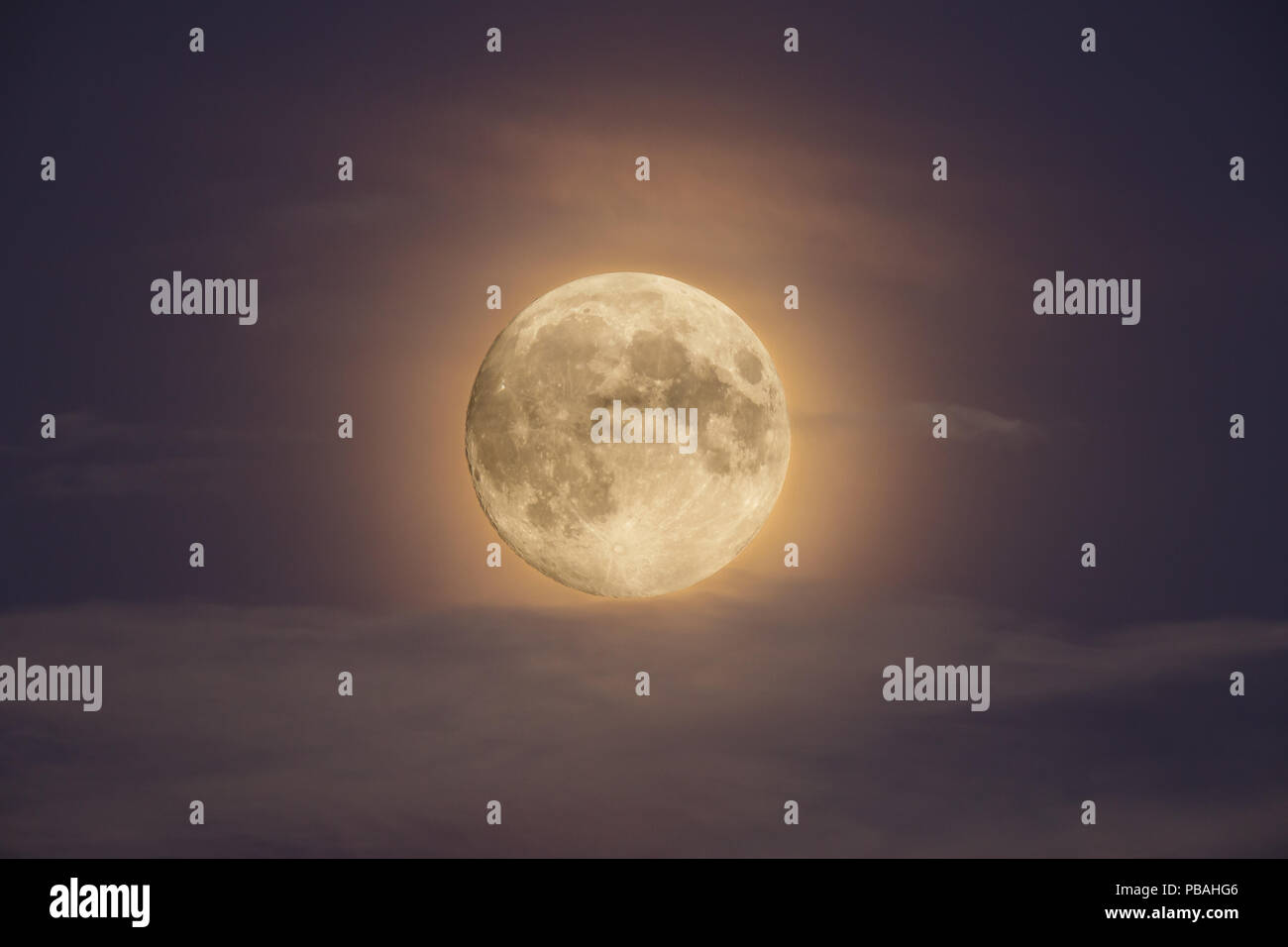 Bright full moon against dark clouds Stock Photo - Alamy