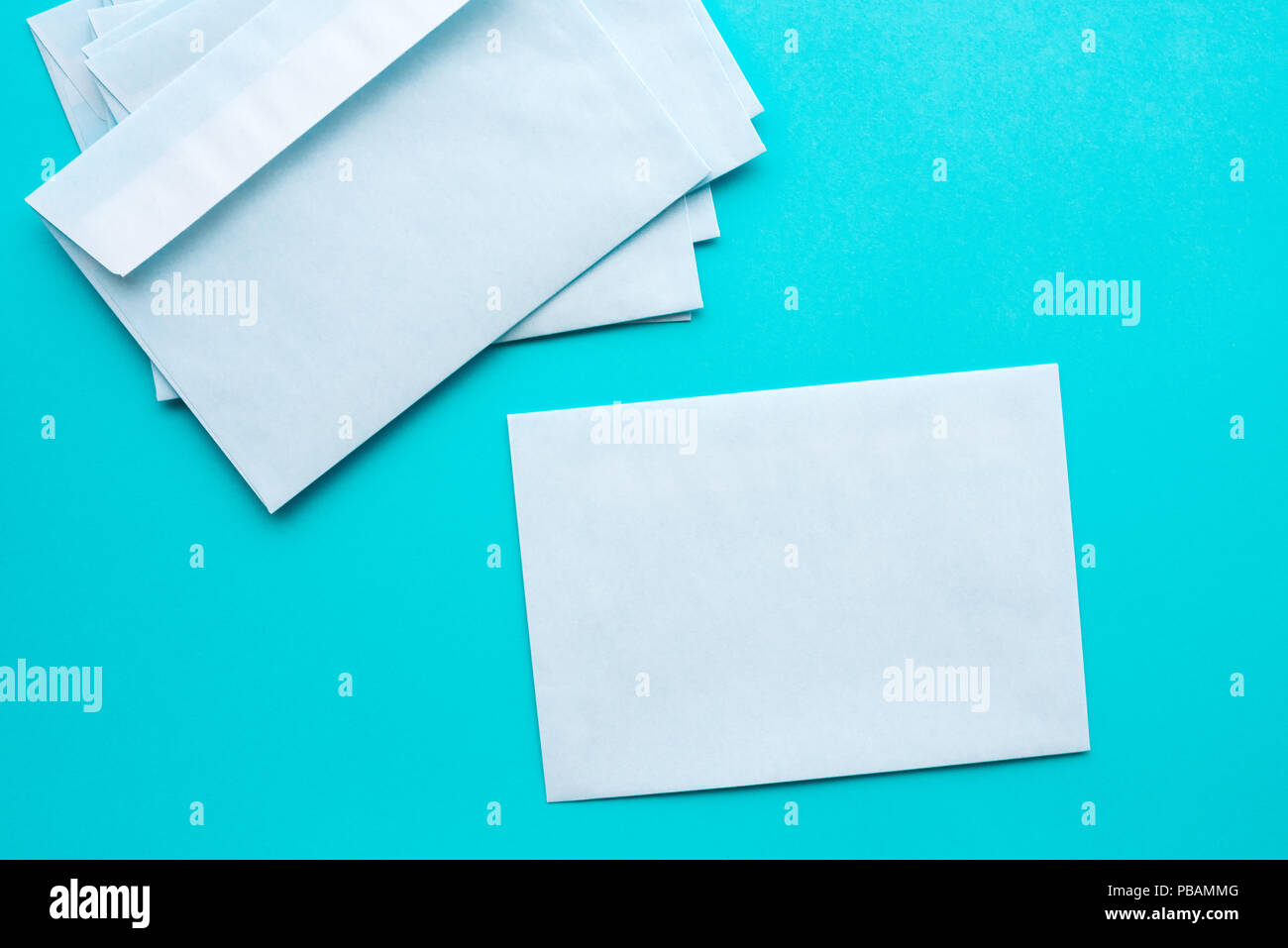 White mail envelopes mock up on blue background Stock Photo - Alamy