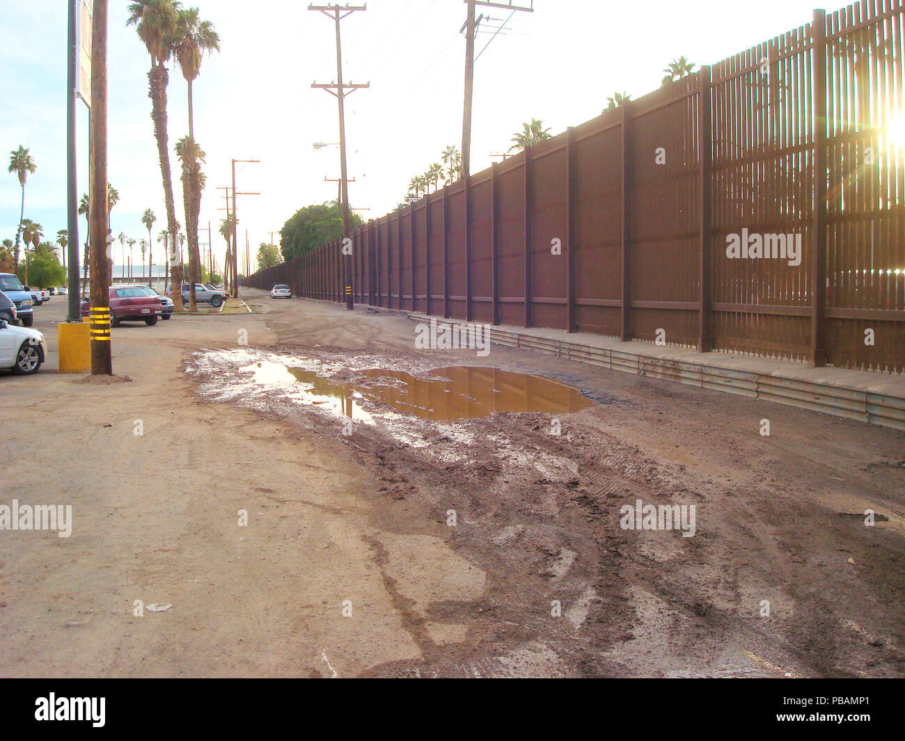 Sun breaking through the border fence between Calexico, California ...