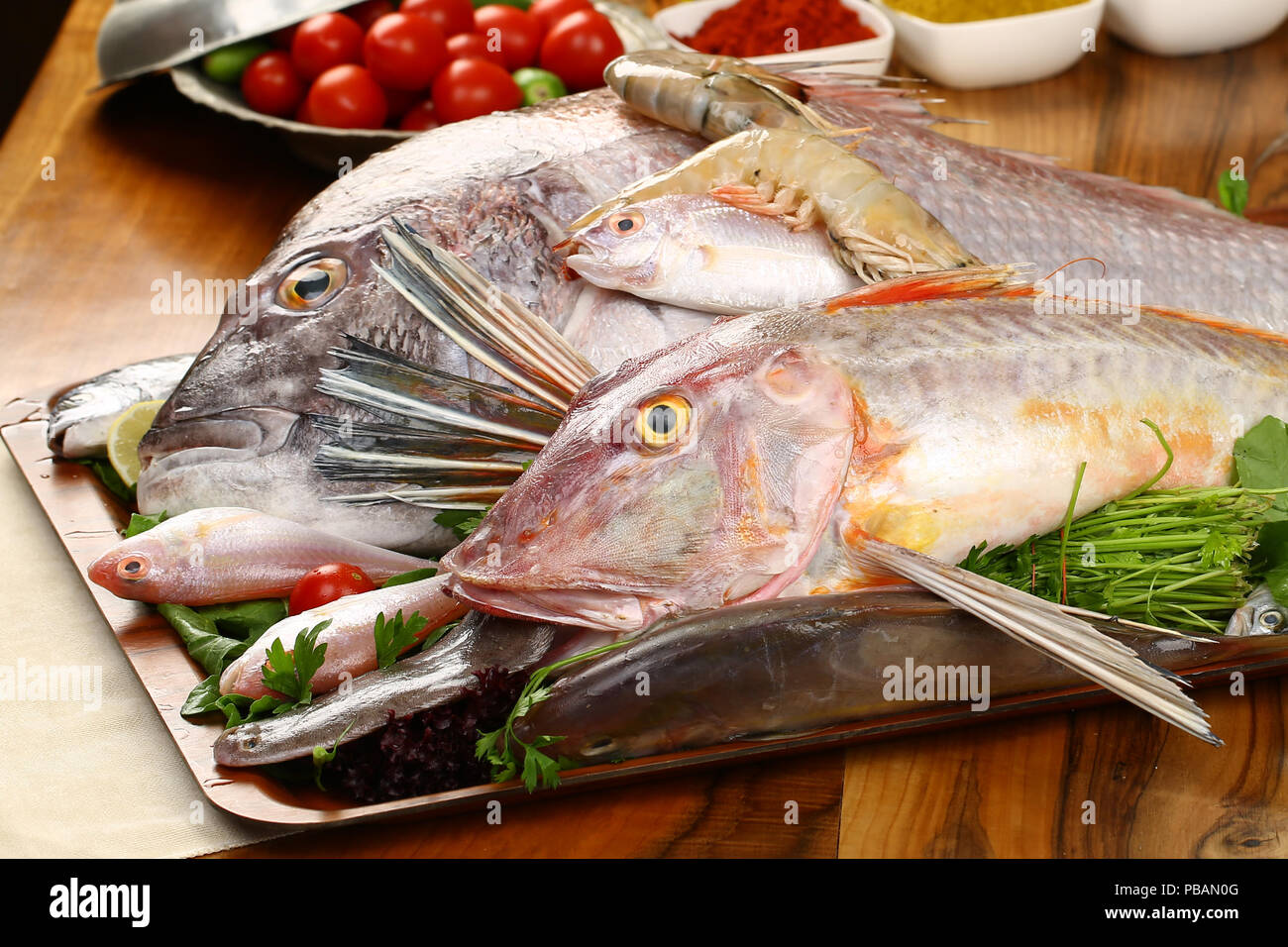 assortment of raw fishes on plate Stock Photo - Alamy