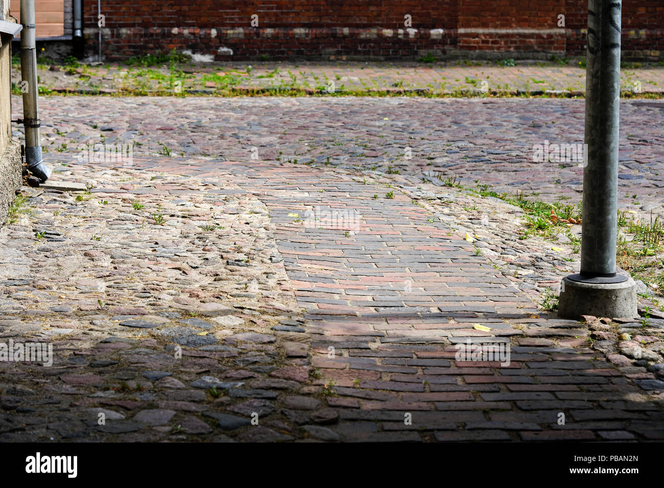 Abstract view of an older paved street with stone blocks of various ...