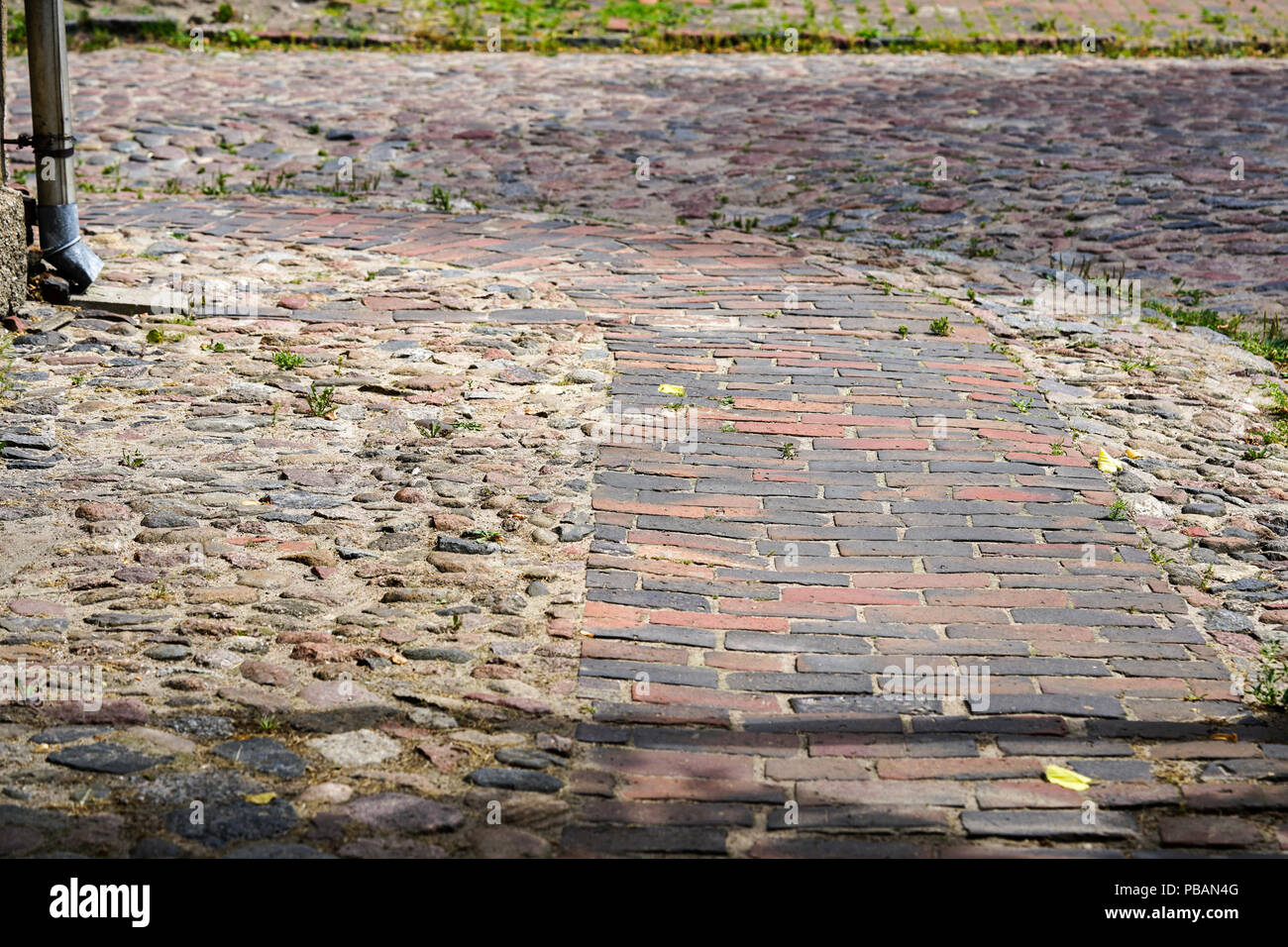 Abstract view of an older paved street with stone blocks of various ...