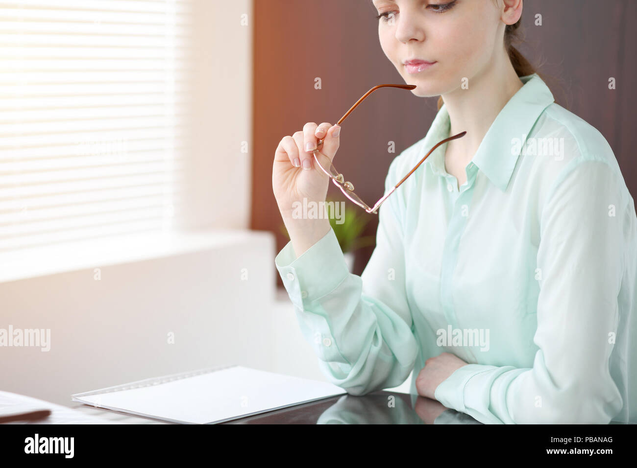 Business woman or secretary sitting at the desk in the office. Green ...