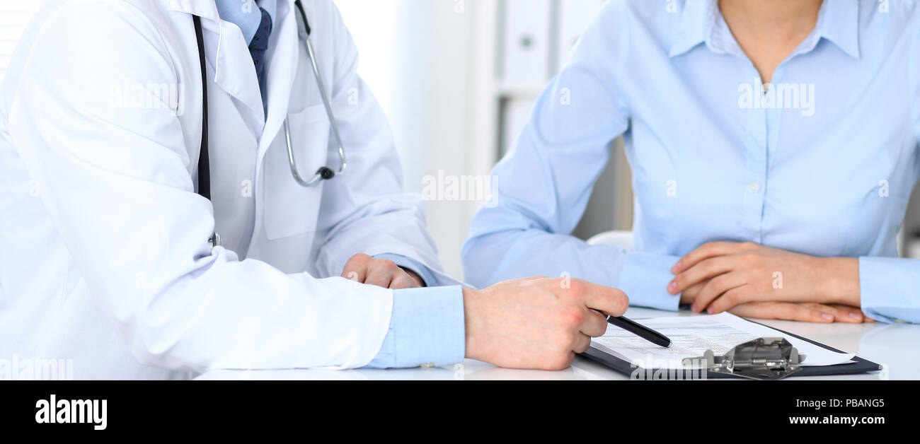 Doctors and patient talking while sitting at the table . Concept of ...