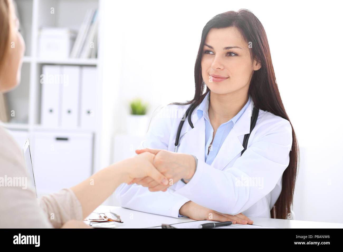 Doctor and patient shaking hands to each other. Healthcare, medicine ...
