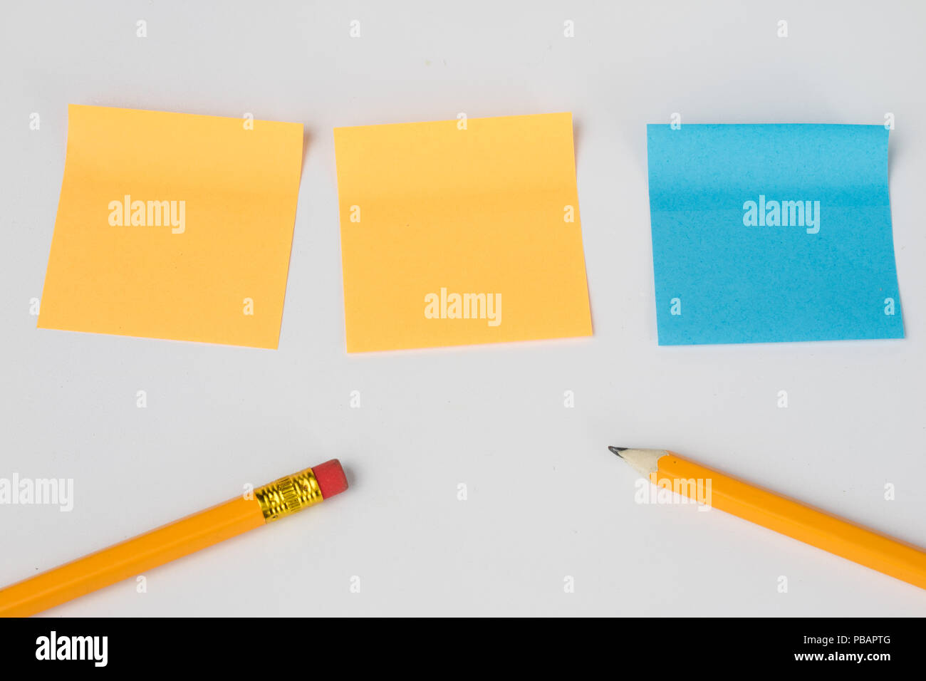Pencil and sticky notes on a white table. Office accessories for saving ...