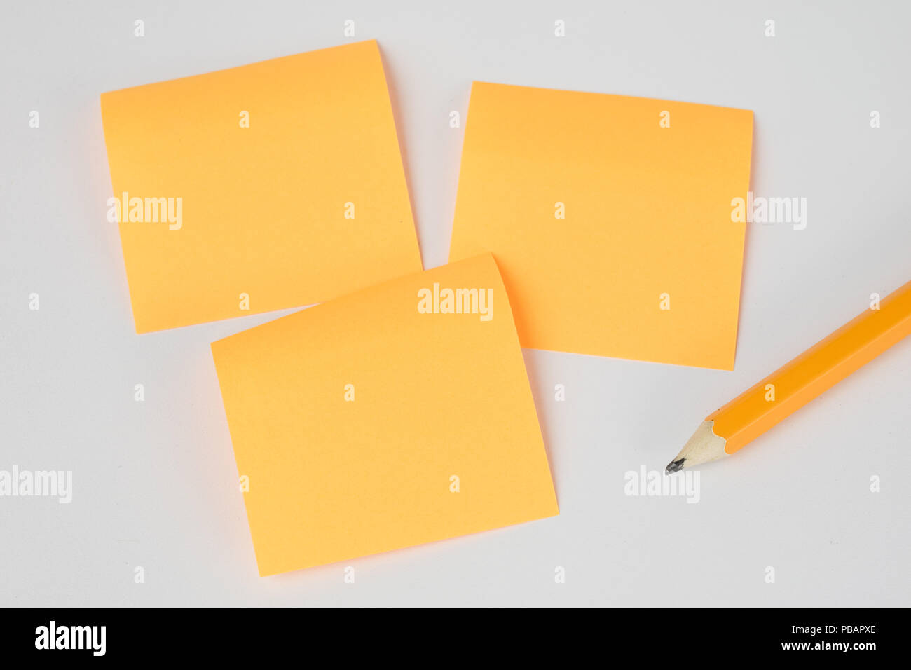 Pencil and sticky notes on a white table. Office accessories for saving ...
