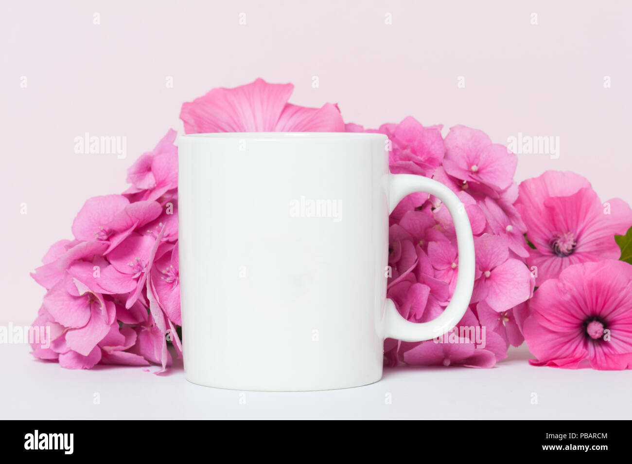 blank white coffee mug mock up with pink flowers Stock Photo - Alamy