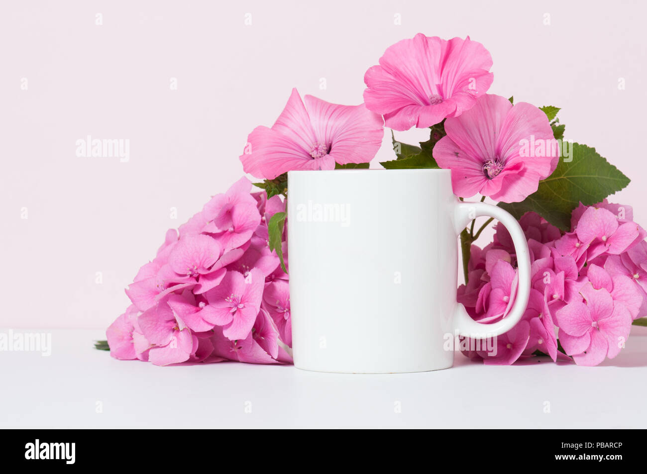 blank white coffee mug mock up with pink flowers Stock Photo - Alamy