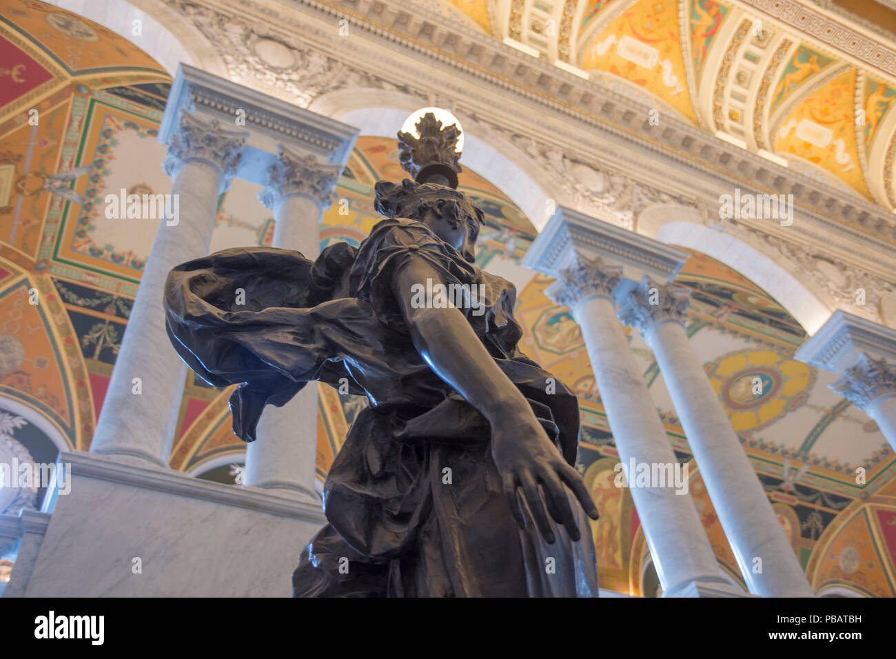 Bronze classical figure holds a "torch of knowledge" In the Great Hall ...