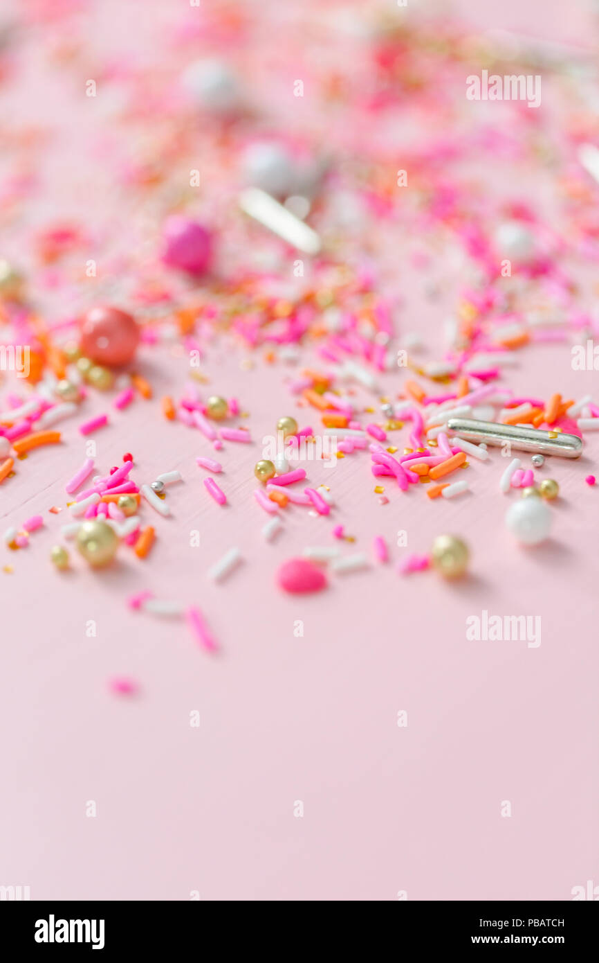 Colorful pink sprinkle blend on a pink background Stock Photo - Alamy