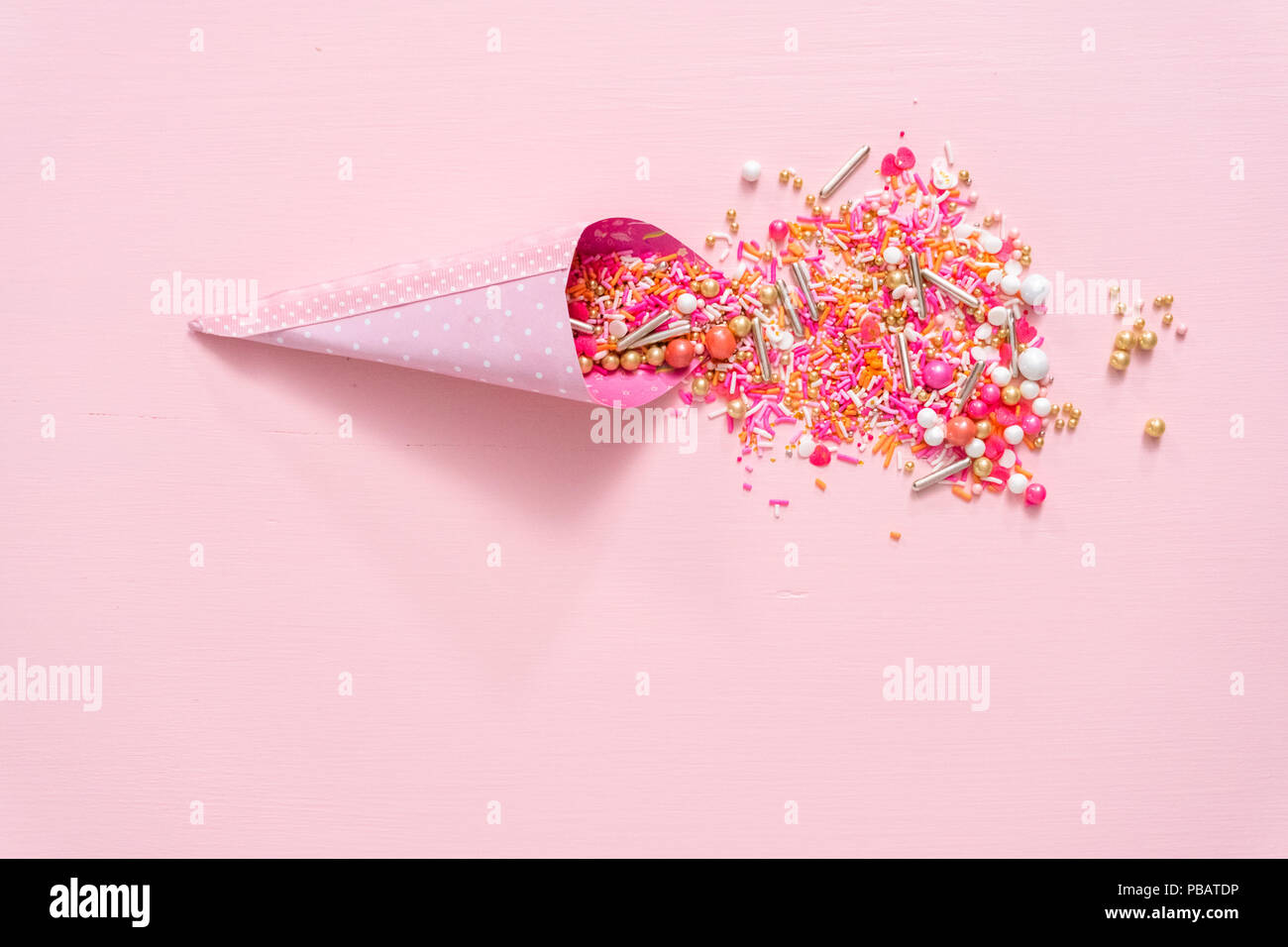 Colorful pink sprinkle blend on a pink background Stock Photo - Alamy