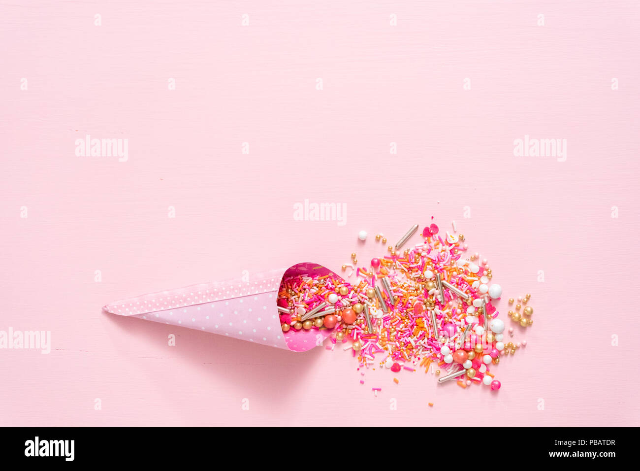 Colorful pink sprinkle blend on a pink background Stock Photo - Alamy