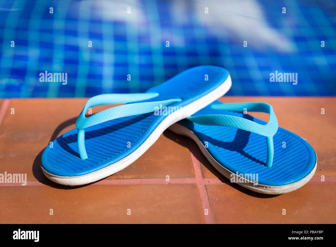 Beach slippers on border of a swimming pool - holiday tropical concept ...