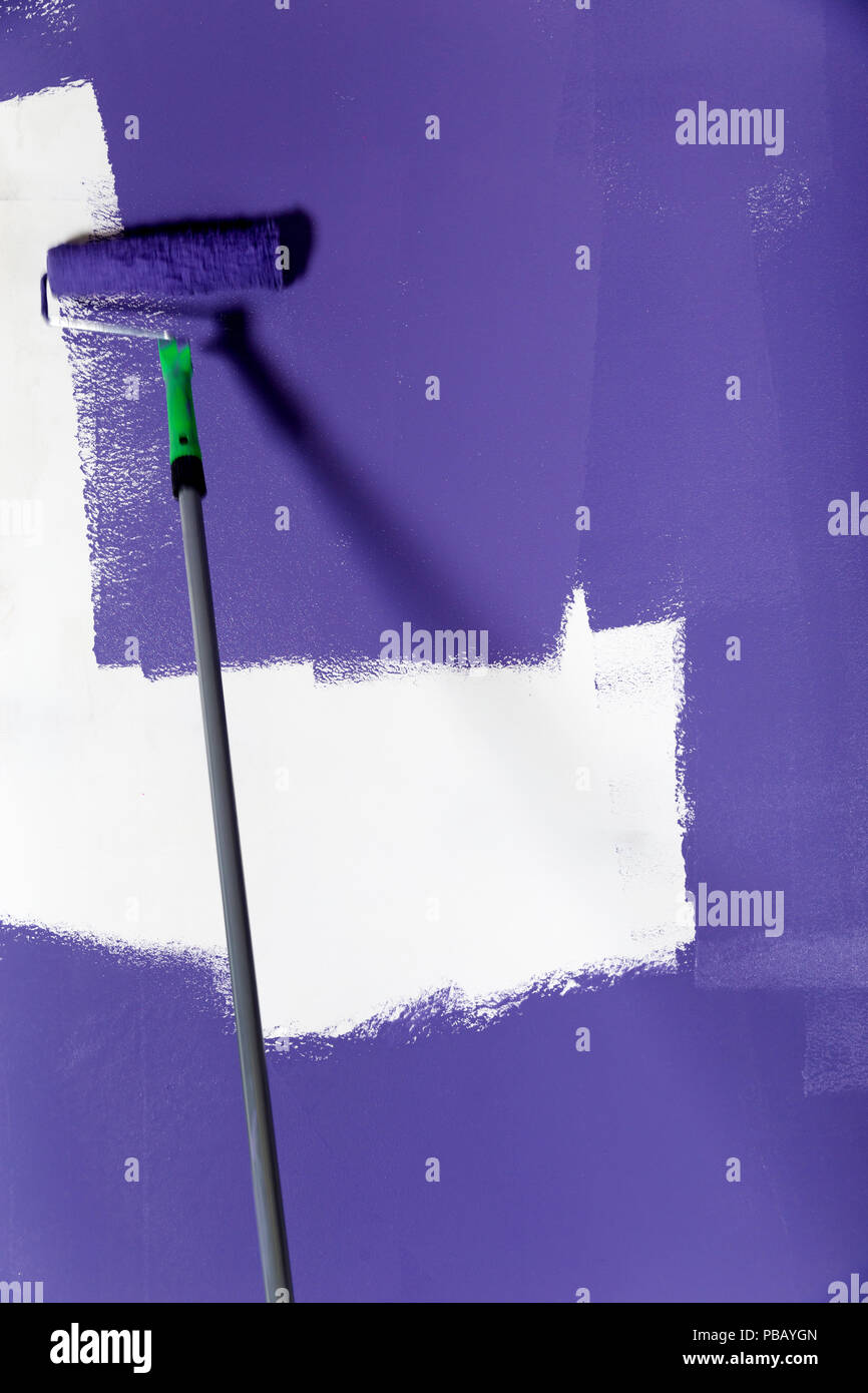 Violet paint roller on a white wall Stock Photo - Alamy