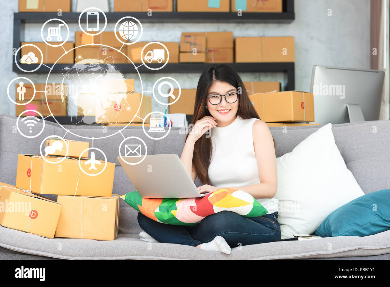 Young asian woman use smartphone and laptop run own business at home ...