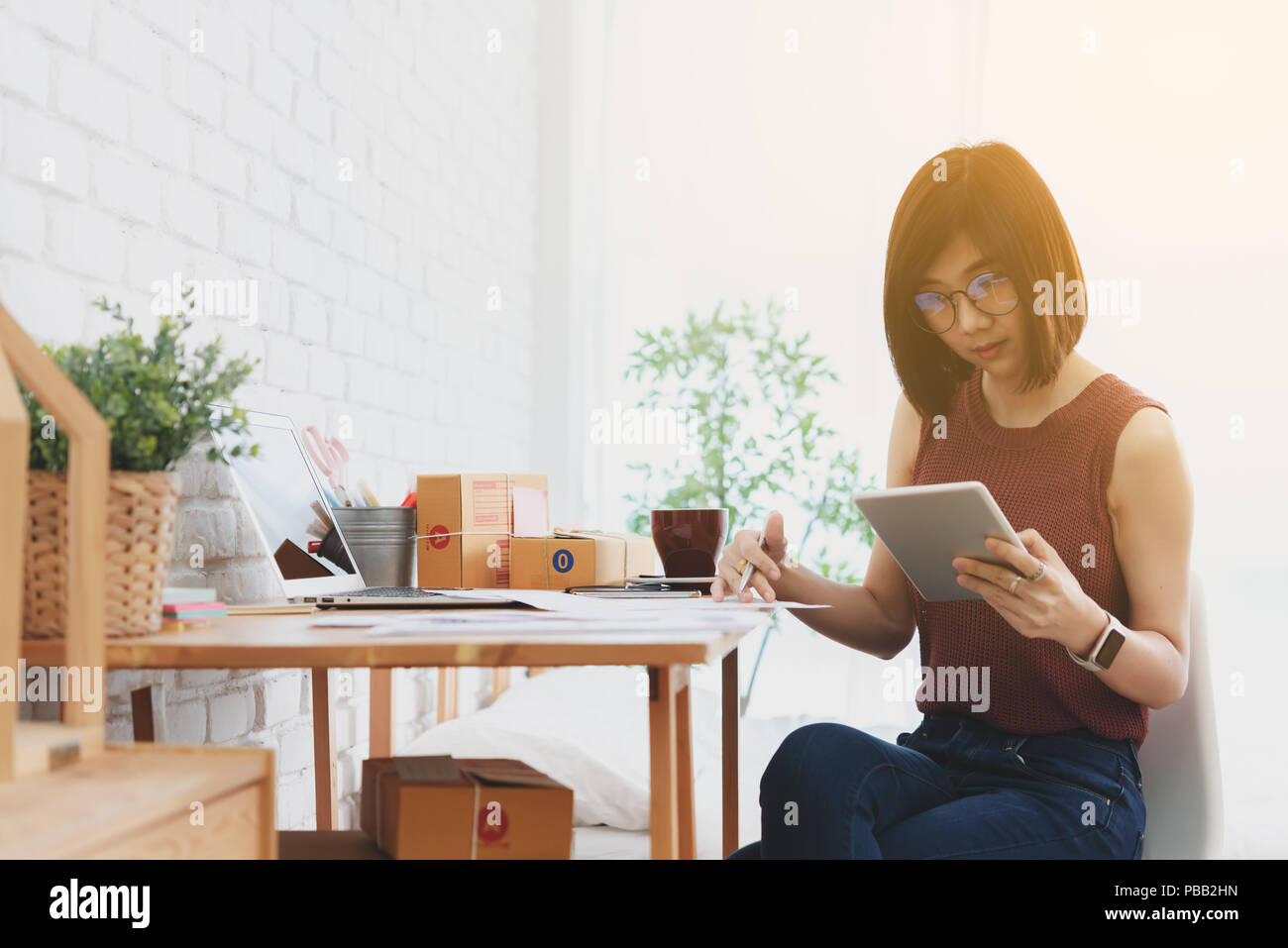 Woman small business owner, business start up conceptual, young entrepreneur work with paper ...