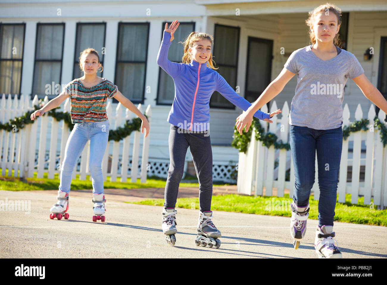 Teen girls group rolling skate in the street outdoor Stock Photo - Alamy