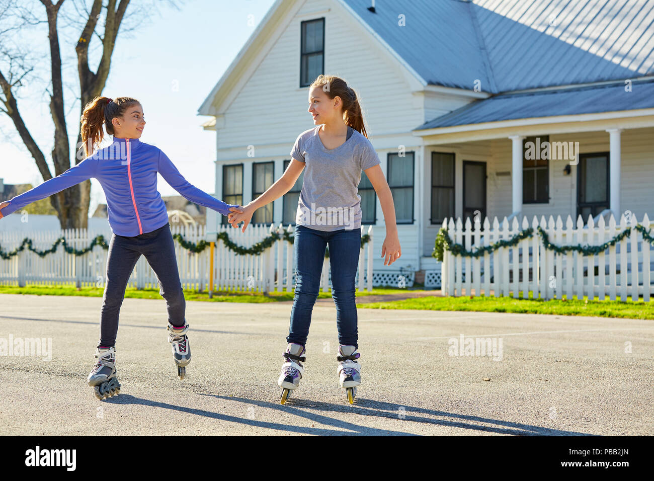 Teen girls group rolling skate in the street outdoor Stock Photo - Alamy