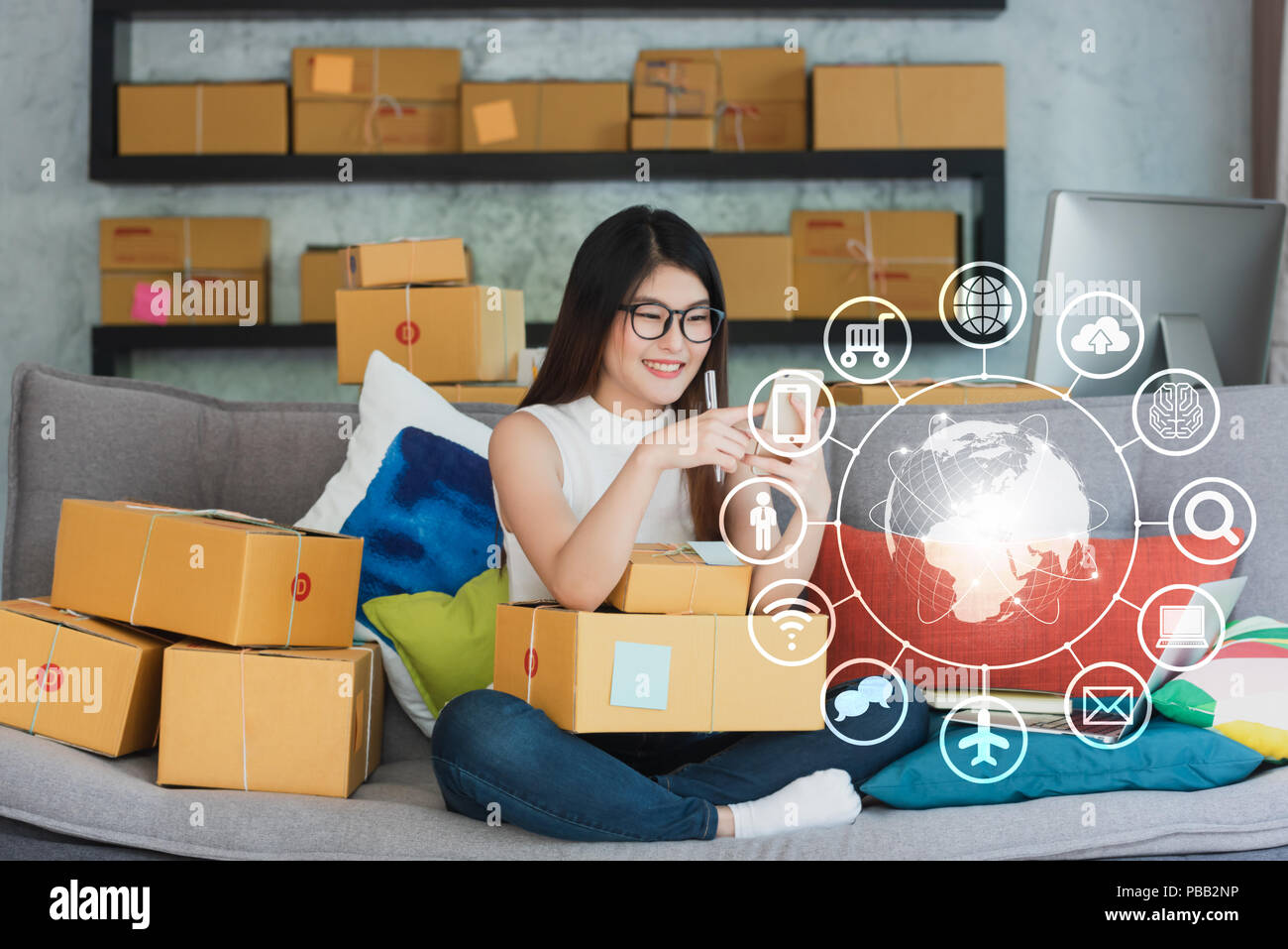 Young asian woman use smartphone and laptop run own business at home ...