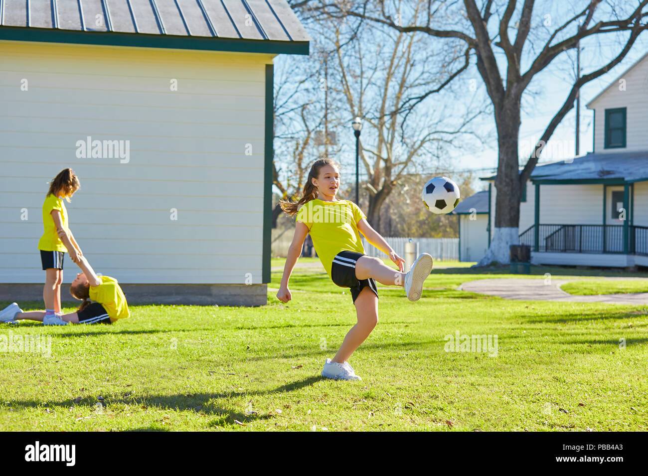 Friend girls teens playing football soccer in a park turf grass Stock ...