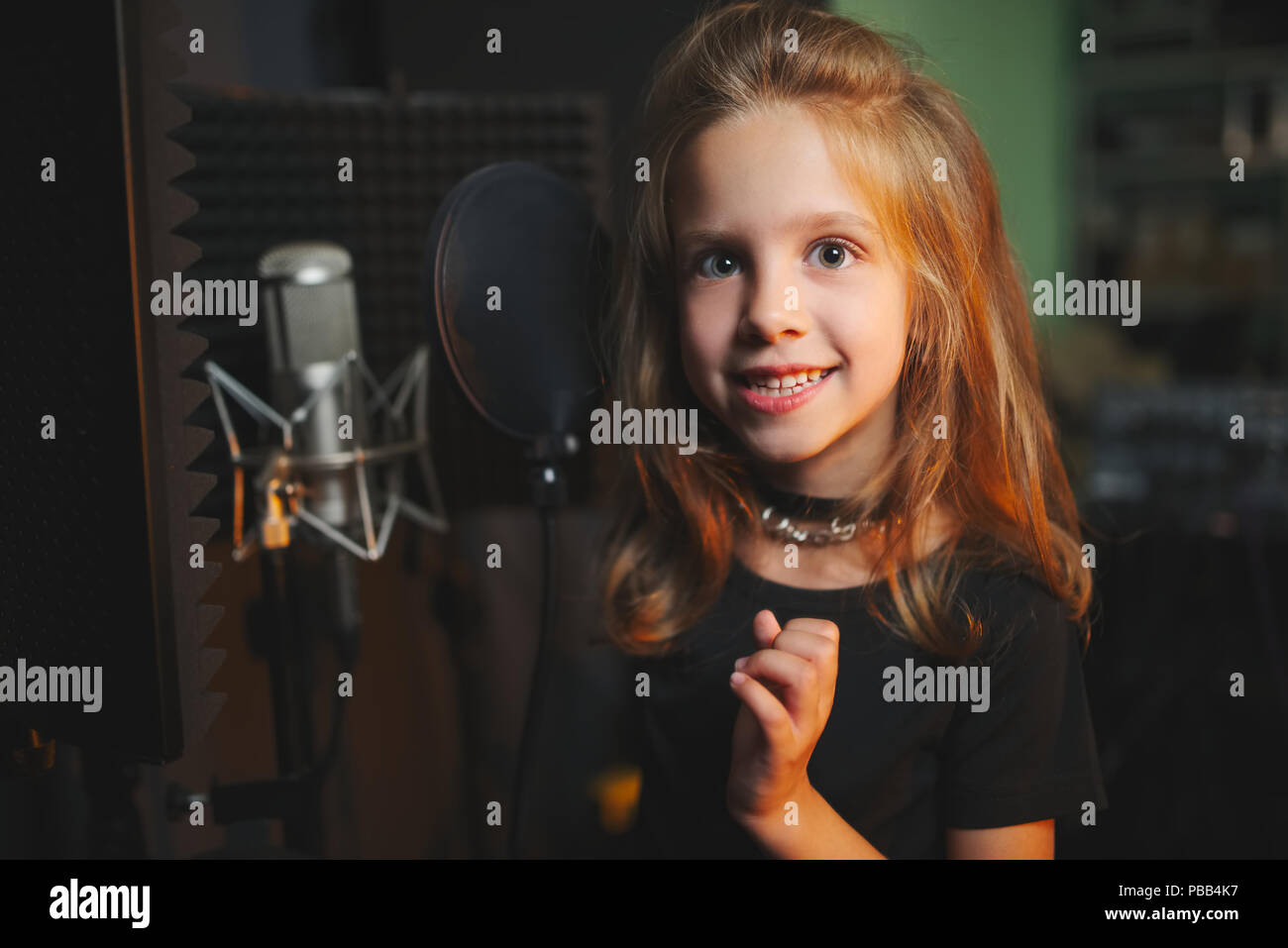 little happy girl singing in recording studio Stock Photo - Alamy