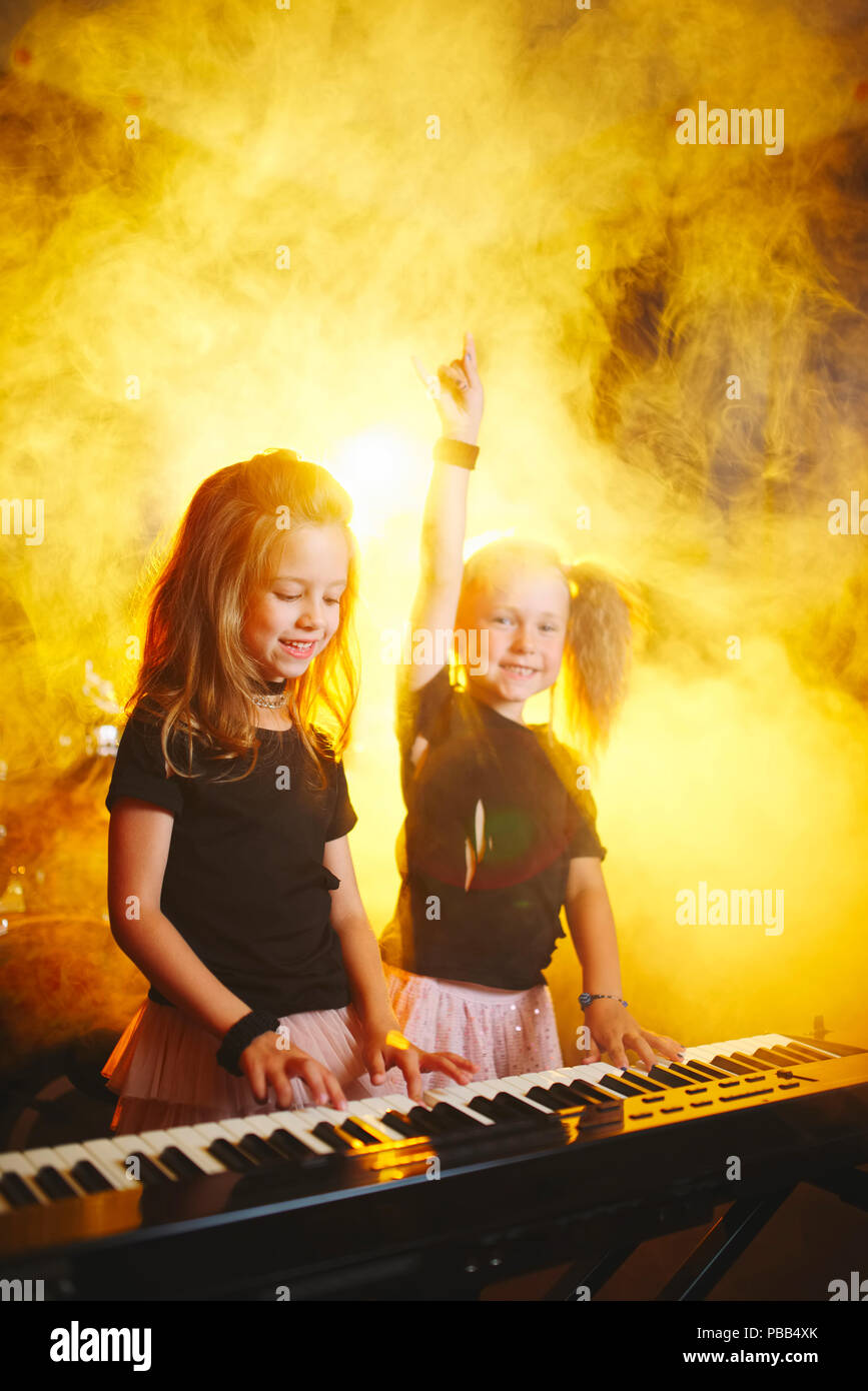 little funny girl play on synthesizer in music studio Stock Photo - Alamy