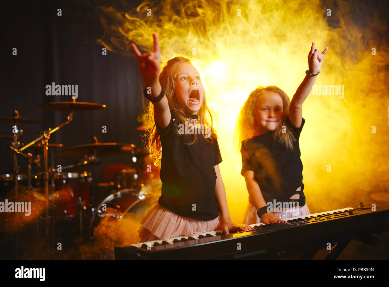 little funny girl play on synthesizer in music studio Stock Photo - Alamy