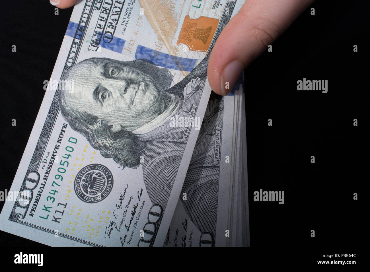 Hand holding American dollar banknotes isolated on white background ...