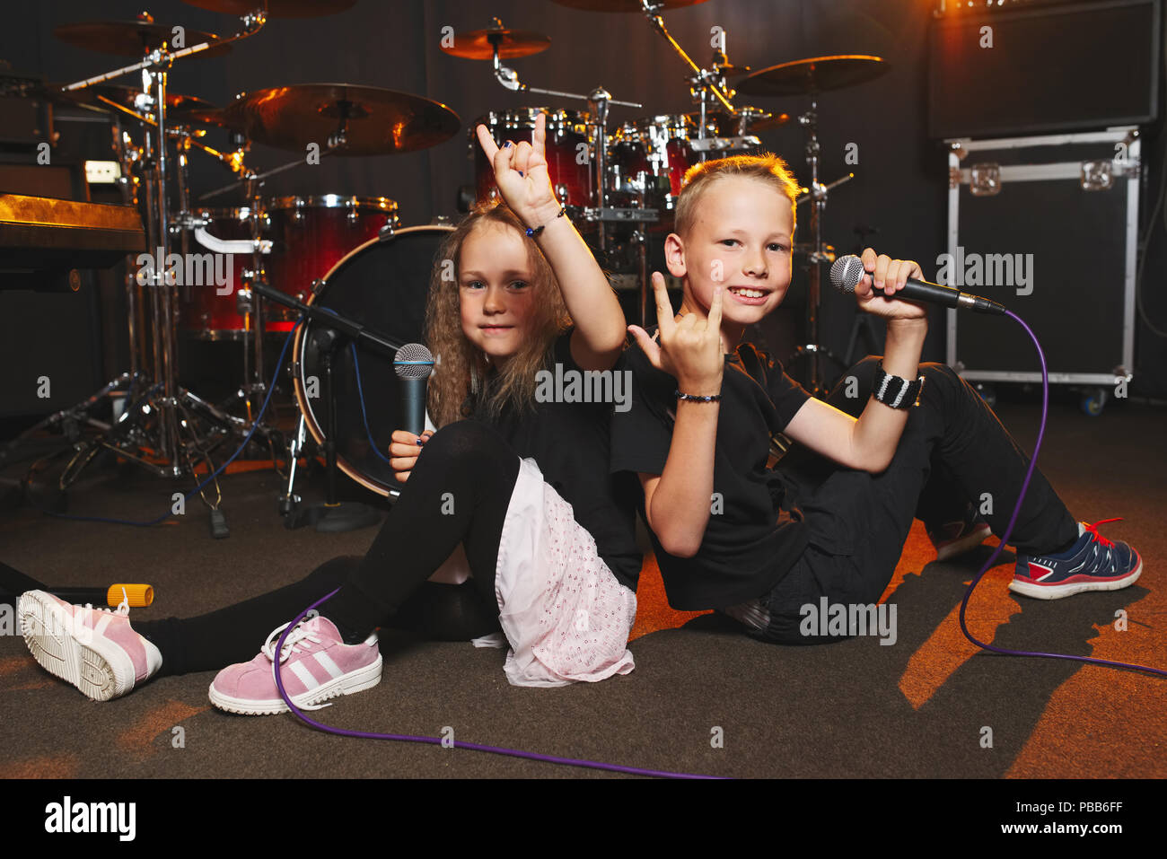 little boy and girl singing in recording studio Stock Photo - Alamy