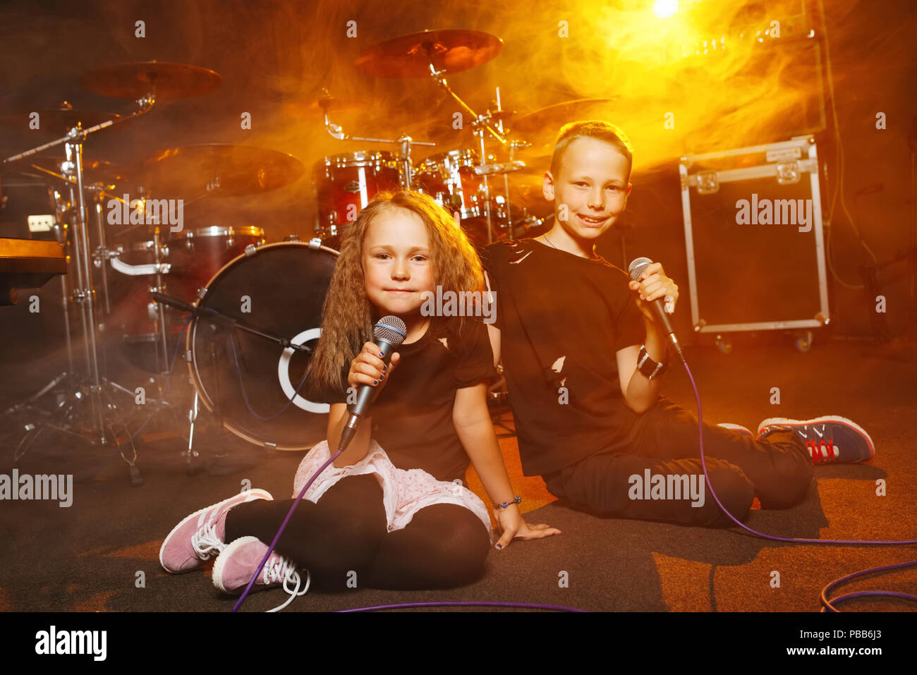 little boy and girl singing in recording studio Stock Photo - Alamy