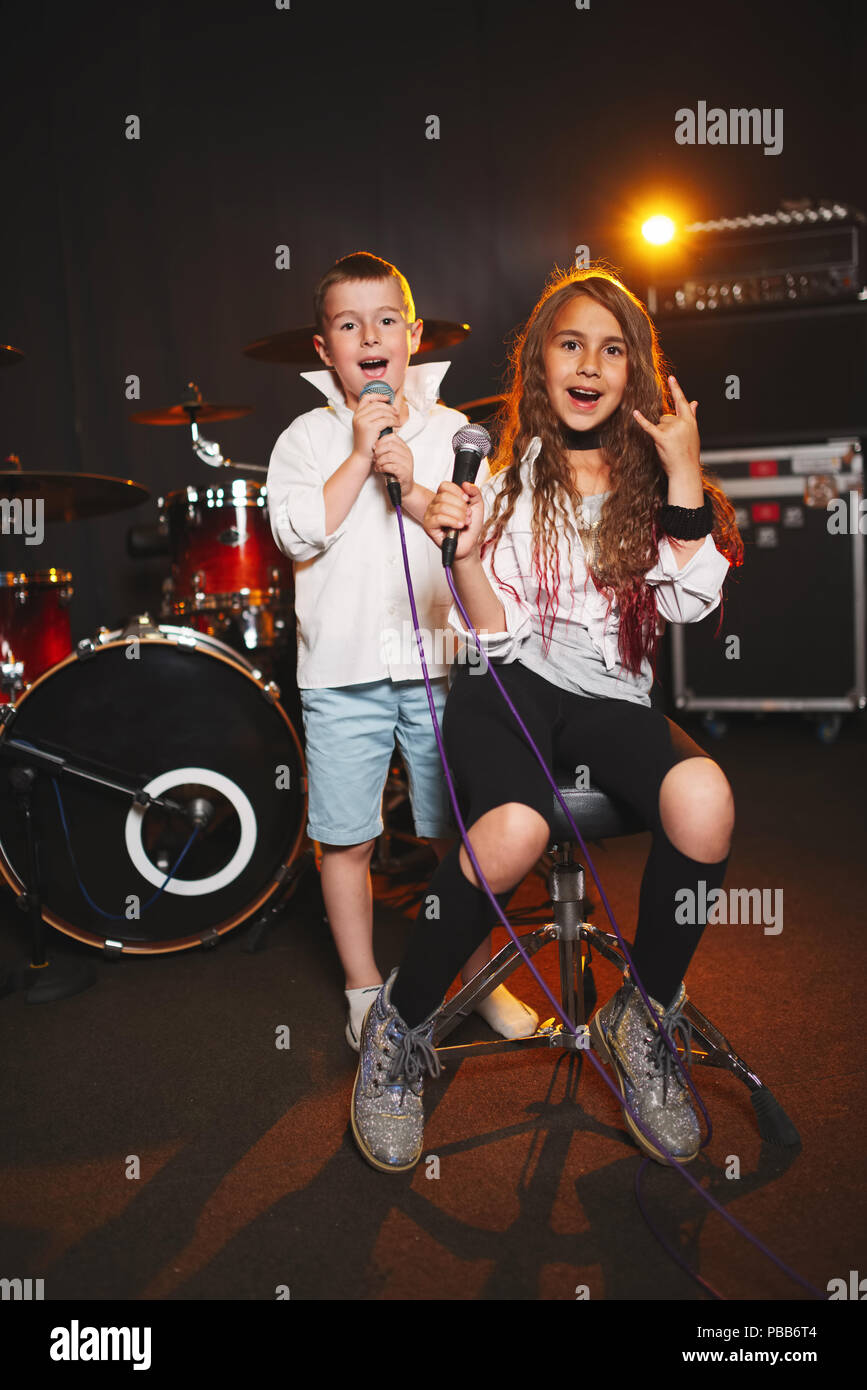 little boy and girl singing in recording studio Stock Photo - Alamy