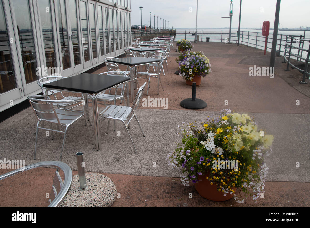 A cafe by the waterside with tables Stock Photo - Alamy