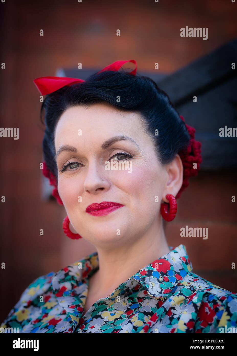 Close-up, front view portrait of attractive smiling lady looking ...
