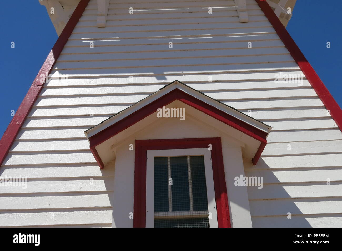 The red & white, square, wooden lighthouse at Covehead Harbour is a ...