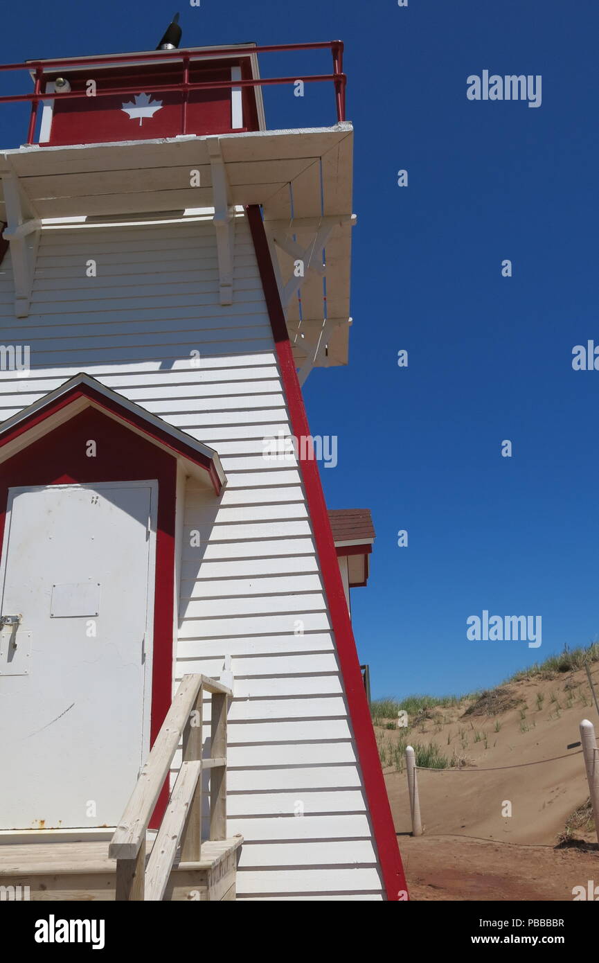 The red & white, square, wooden lighthouse at Covehead Harbour is a ...