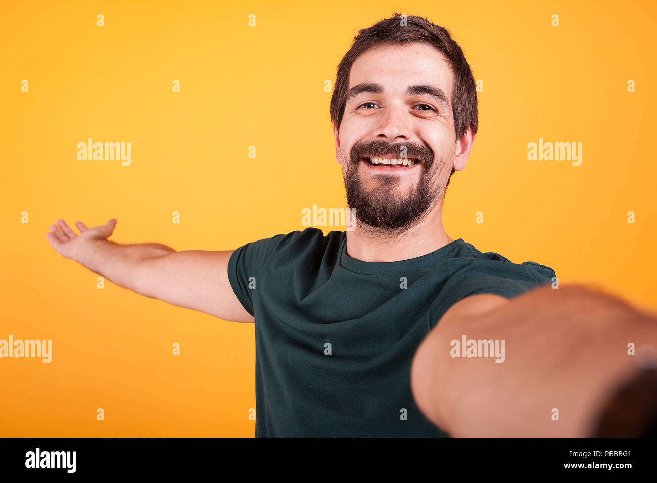 Cool smiling handsome guy smiling at the camera while taking a selfie ...