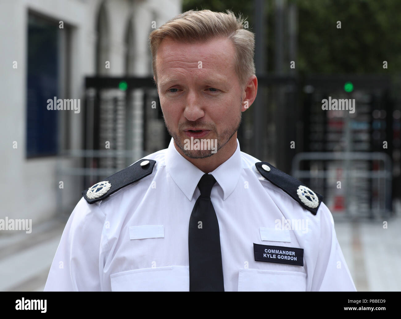 Commander Kyle Gordon speaking to the media outside New Scotland Yard ...