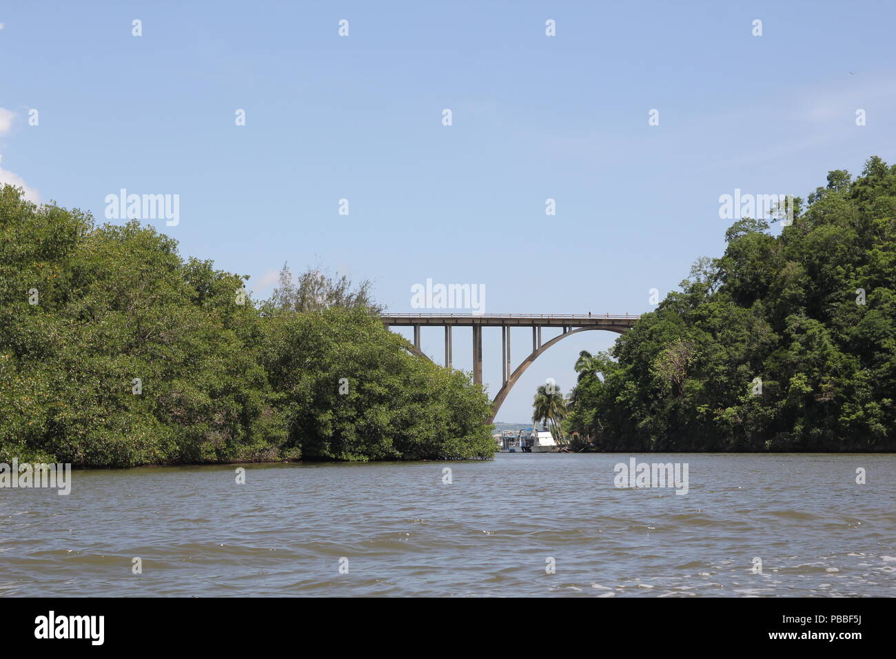 Very high arched bridge over a wide river, Cuba Stock Photo - Alamy