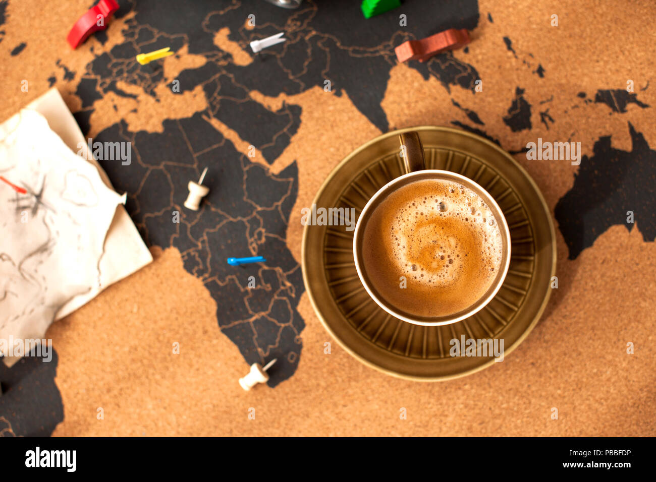 A cup of fragrant coffee on the map, a vintage photo. Travel and ...