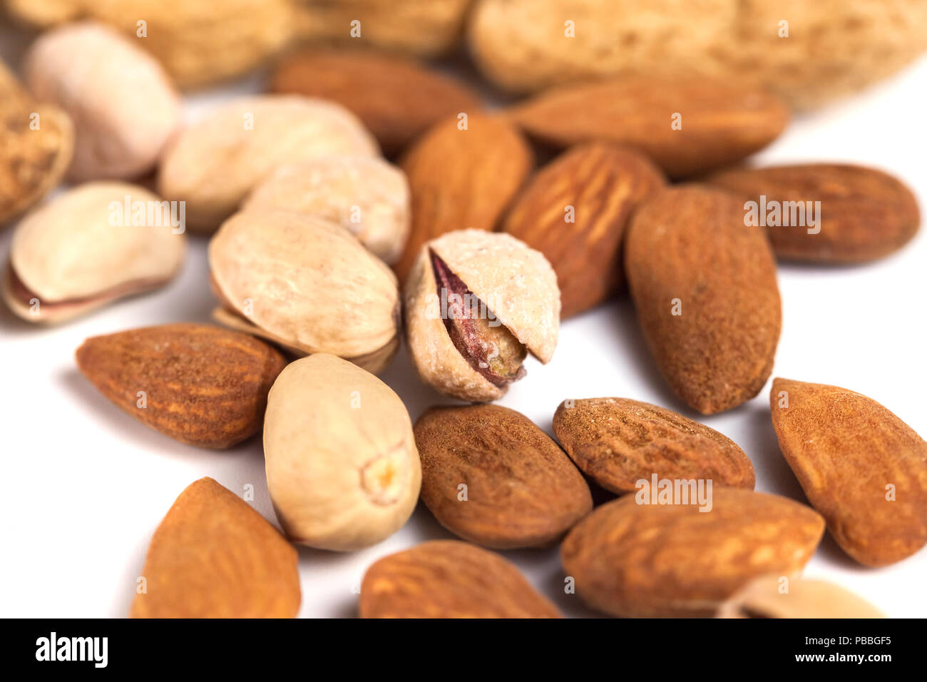 Mix of nuts close up on white background Stock Photo - Alamy