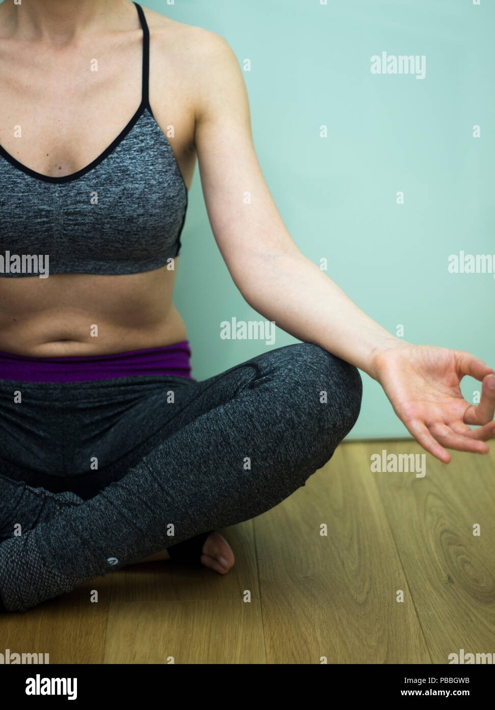Female instructor yoga teacher teaching asana pose with mudra hand ...