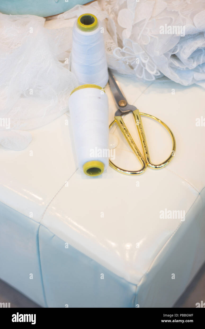 Bridal store hand made dress shop window with scissors, thread and ...