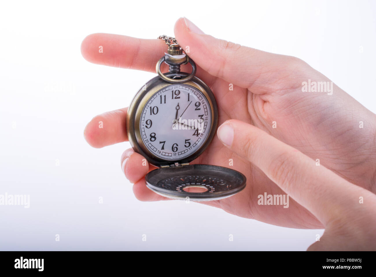 Hand holding a retro styled pocket watch in hand Stock Photo - Alamy